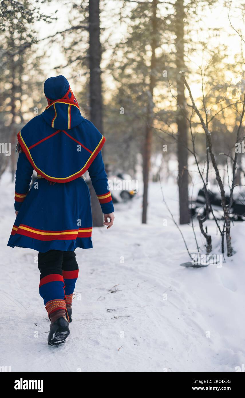 Back view anonymous indigenous person in gakti and nutukas walking on ...