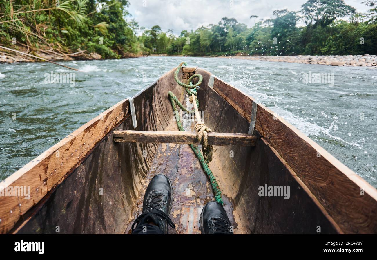Traditional wooden boat with rope tied from bow to wooden plank riding ...