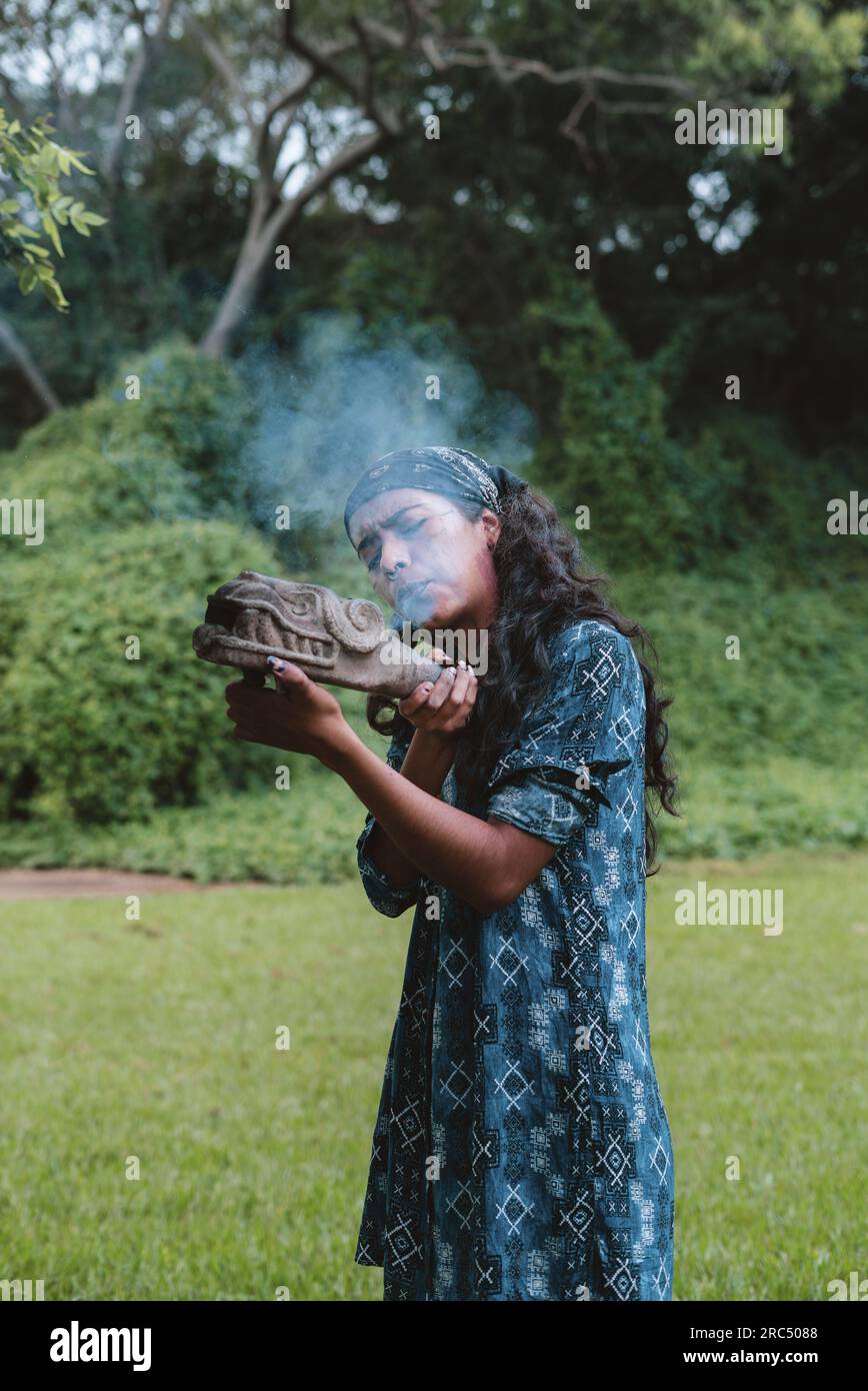 Serious young female in casual clothes and long hair holding reptile ...