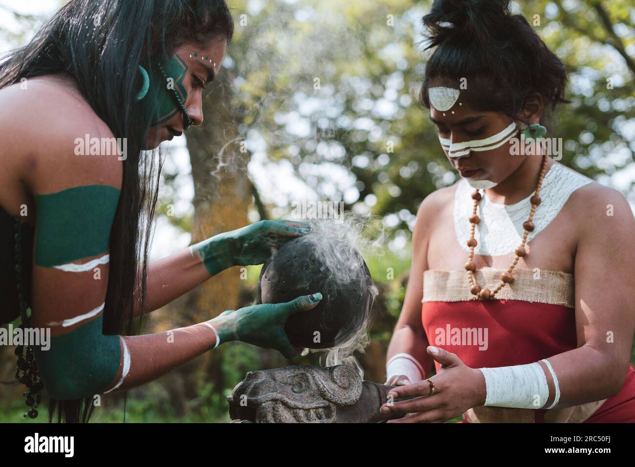 Side view of young ethnic female Mayan warriors in traditional clothes ...