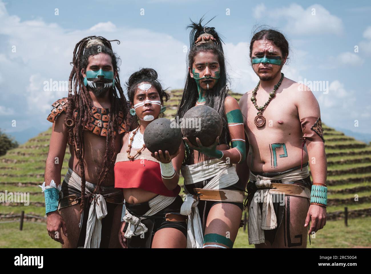Group of serious Mayan warriors in traditional costumes with face ...