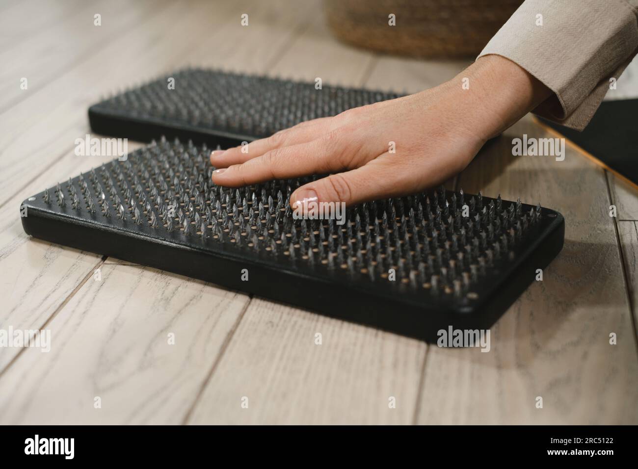 Crop unrecognizable female yogi touching a pair of sadhu nail boards ...