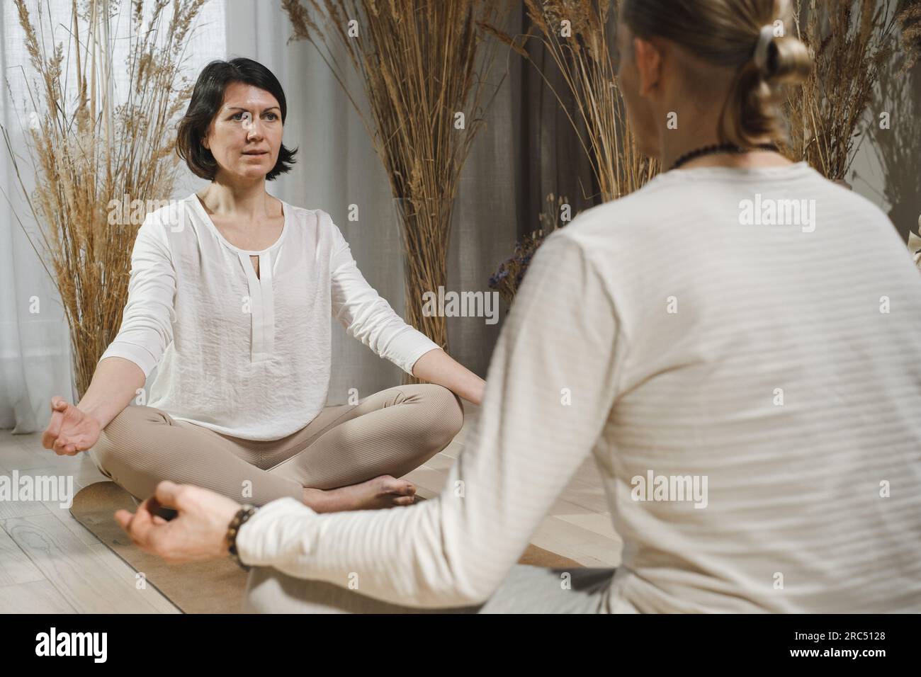 Husband and wife relaxing in Padmasana yoga pose with hands in Gyan ...