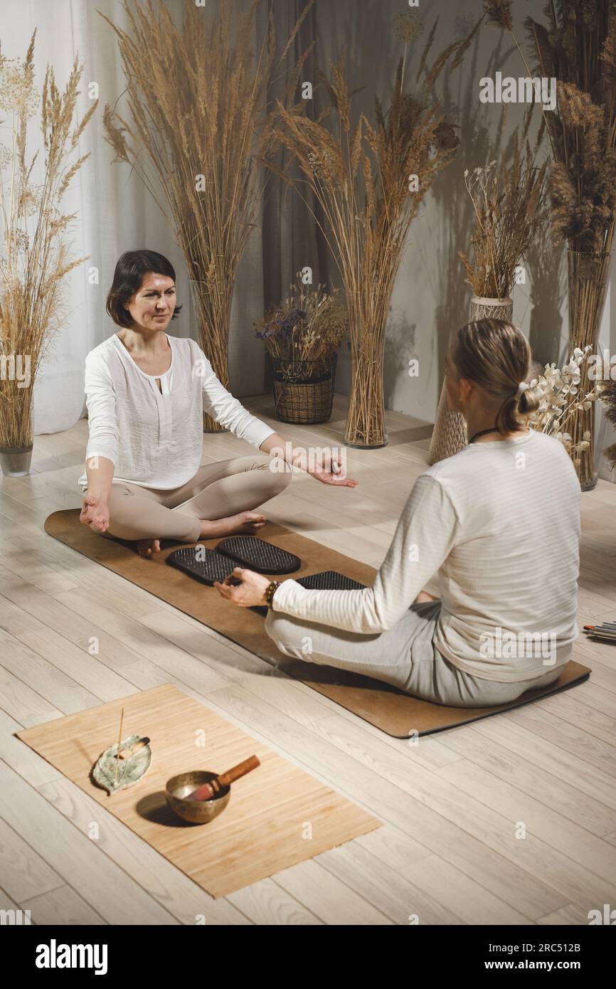 From above of husband and wife relaxing in Padmasana yoga pose with ...