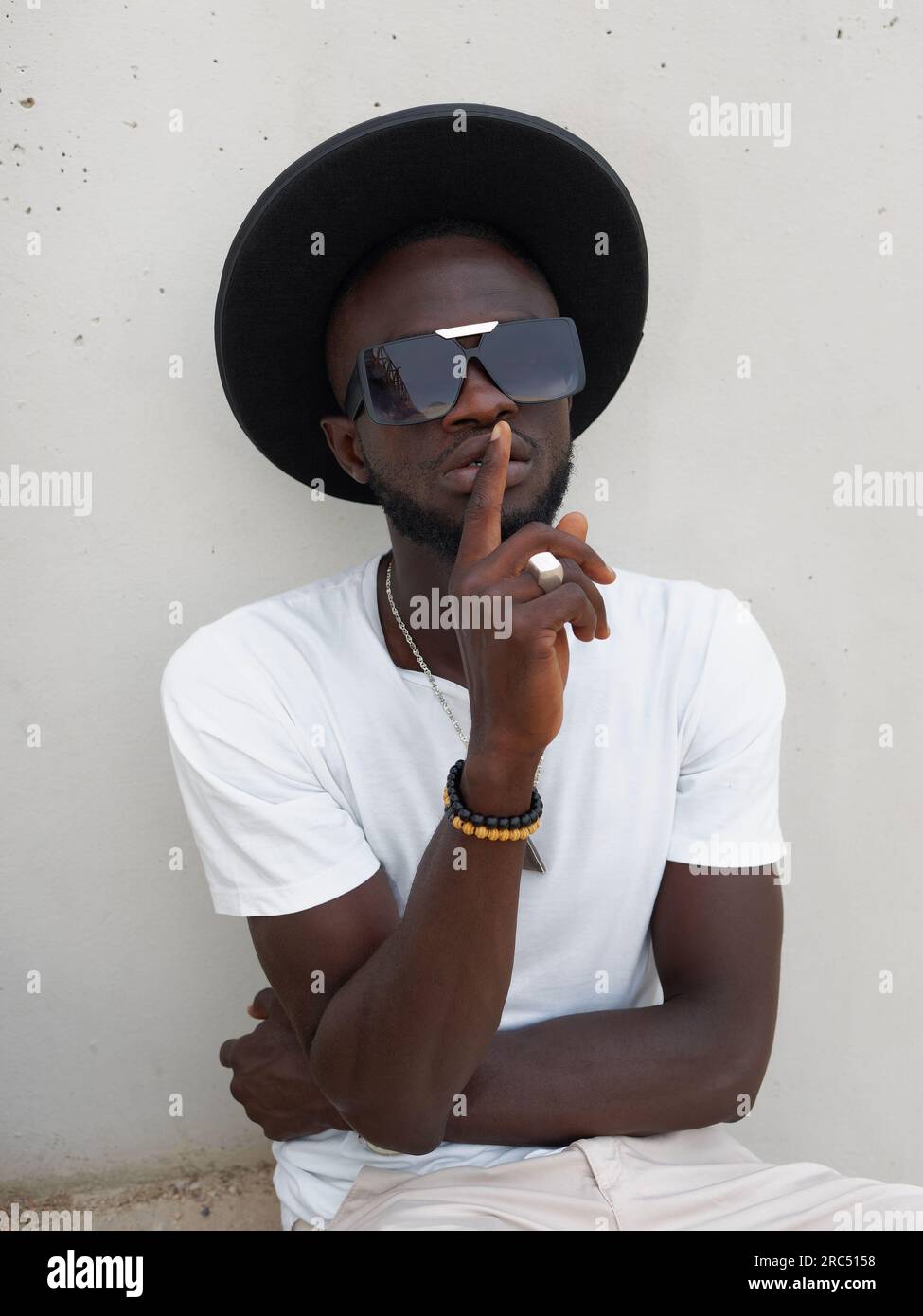 Serious young bearded African American male model in casual clothes ...