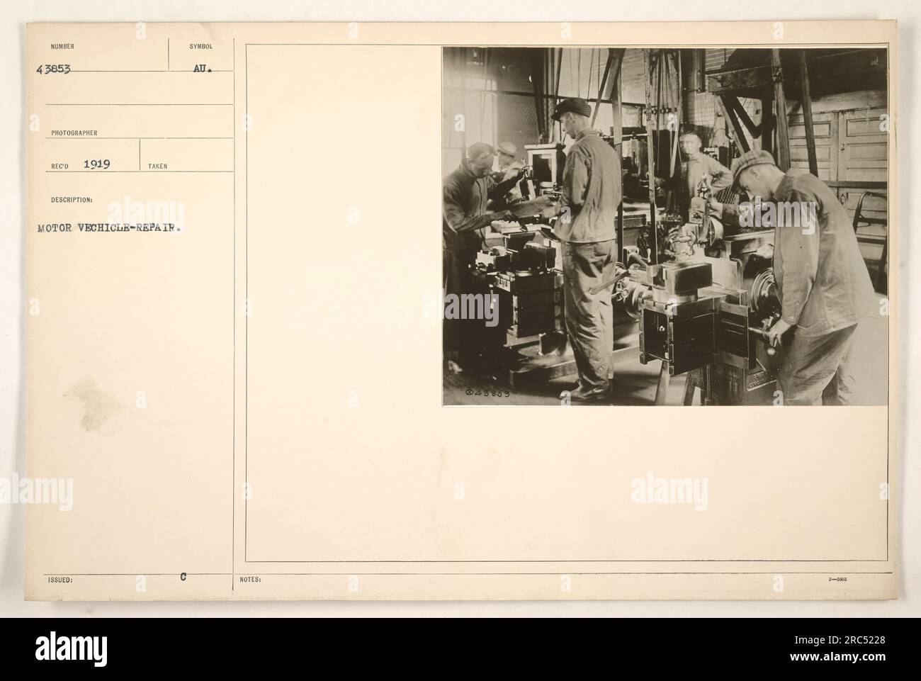 U.S soldiers working on repairing a motor vehicle during World War One ...