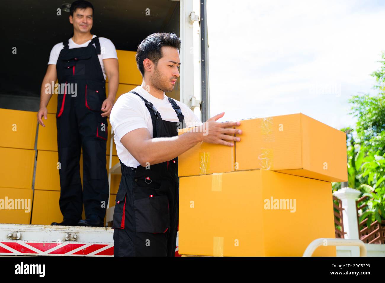 Happy two delivery men in front of delivery truck, Delivery men ...