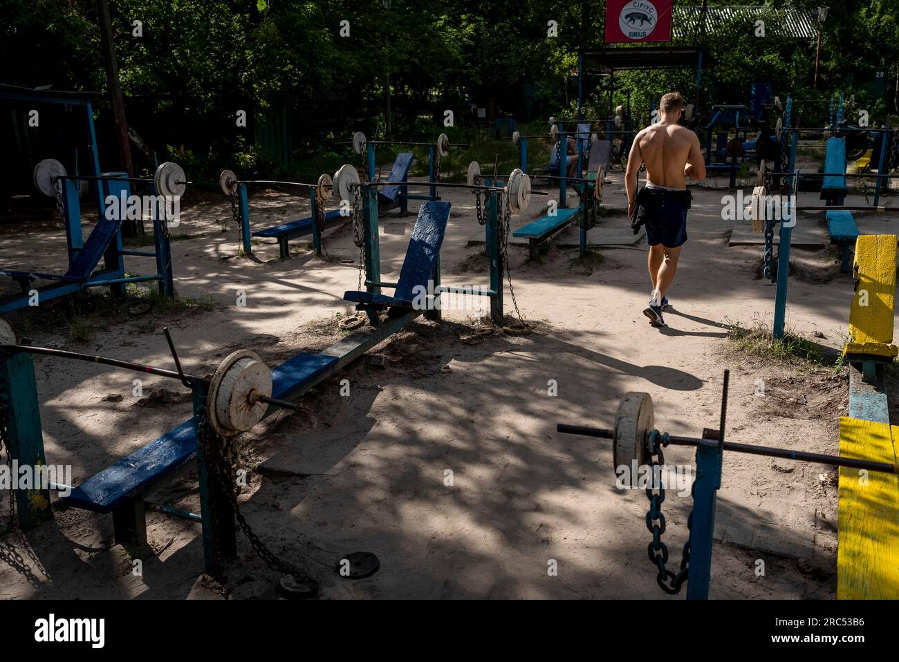 A man walks past gym equipment built with scrap metal at the Kachalka ...