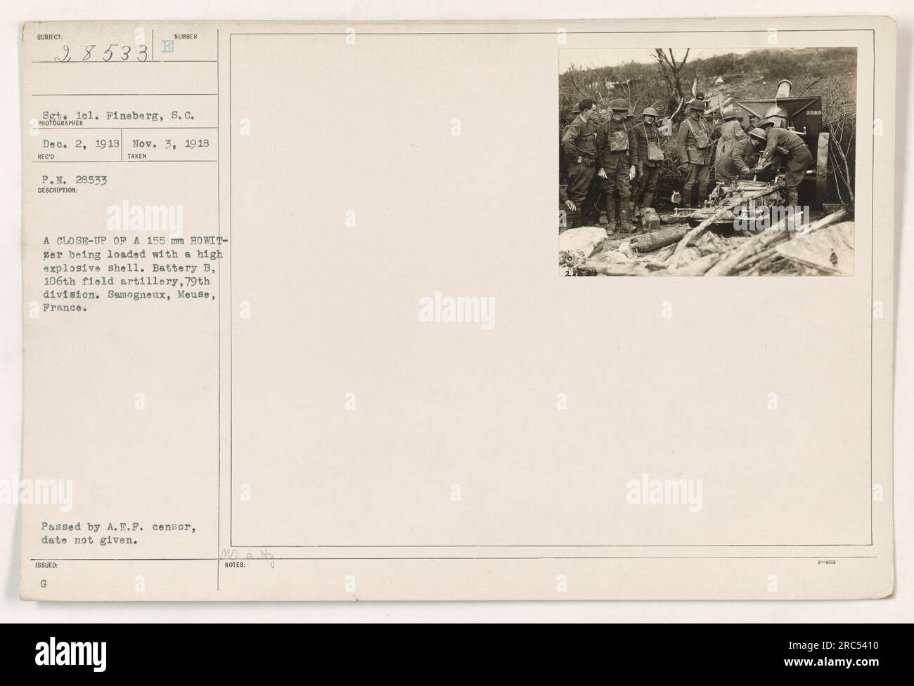 Caption: A close-up photograph of a 155 mm howitzer being loaded with a ...