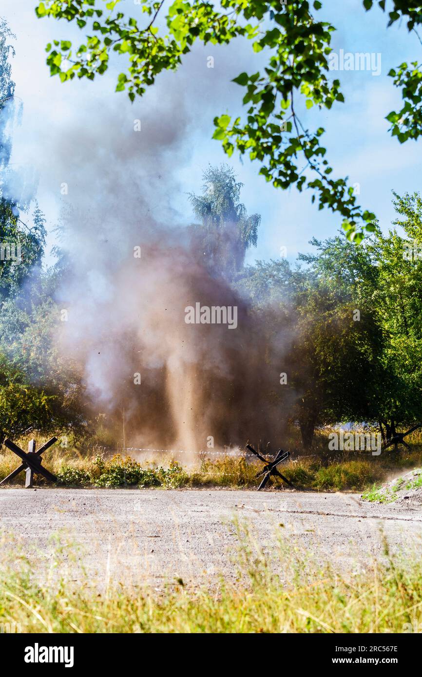 Background. Bomb exploding between the trees . Reconstruction of battle ...