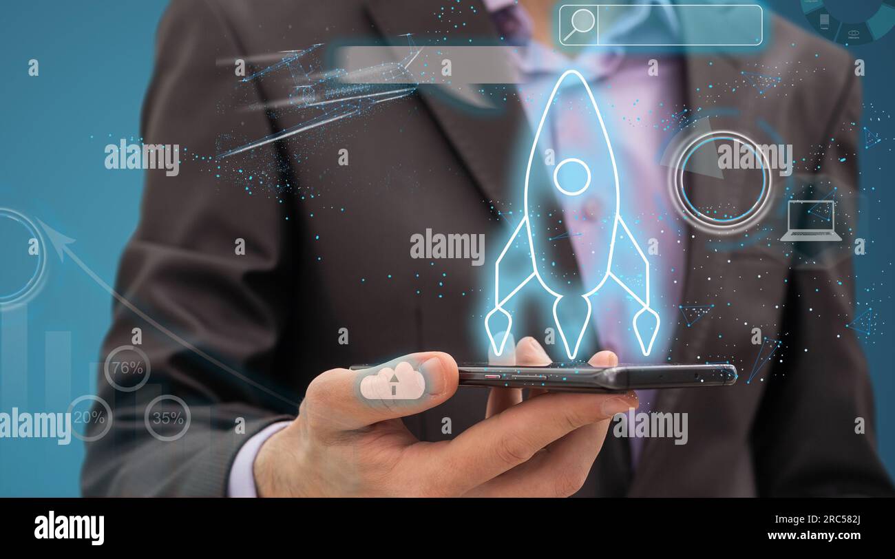 Startup concept with businessman holding tablet or smartphone ...