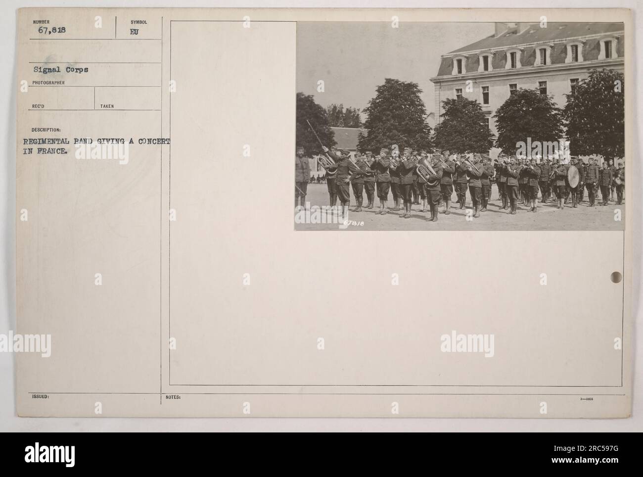 Regimental band members playing musical instruments and dressed in ...