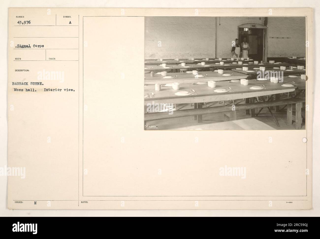 Interior view of a mess hall in the barracks during World War One. The ...