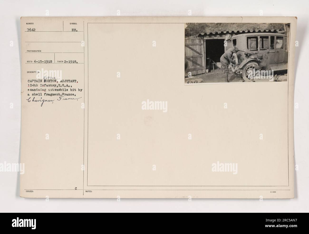 Caption: Captain Norton, adjutant of the 104th Infantry, examines an ...