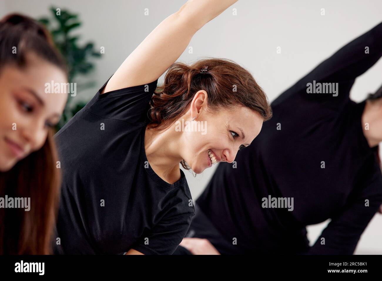 Close up image of beautiful women doing pilates in a bright studio ...