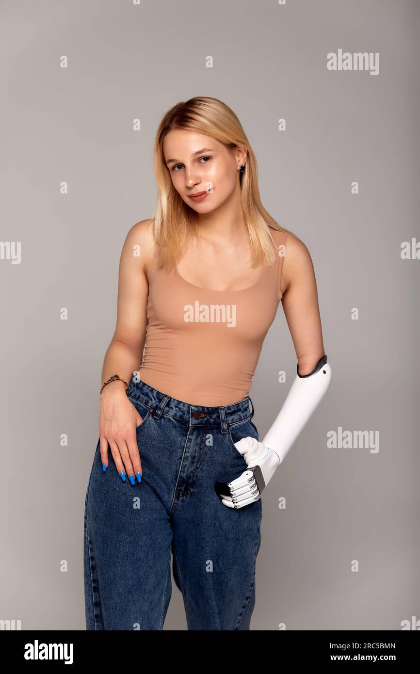 Studio half-length portrait of beautiful young blonde girl with ...