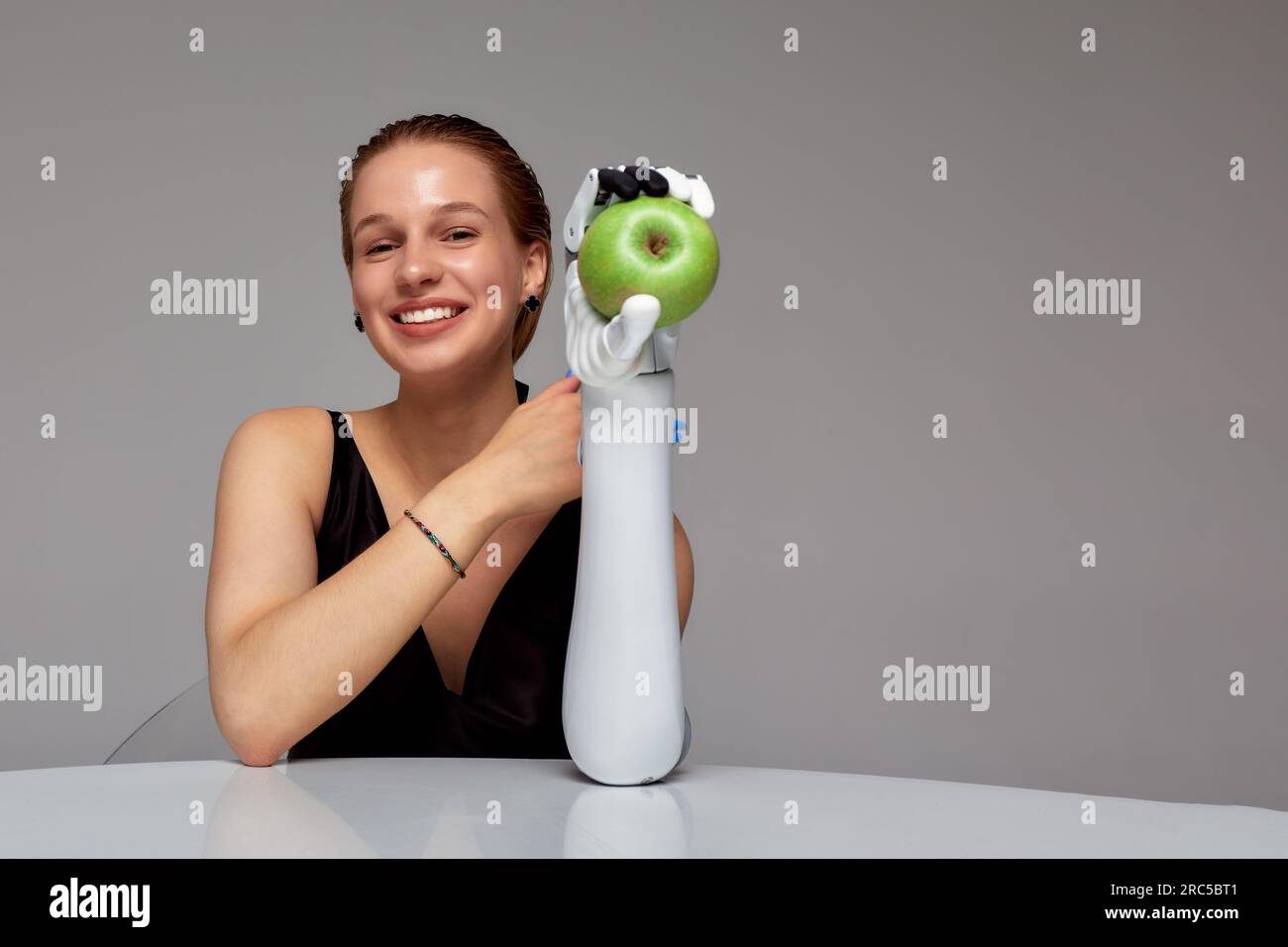 Young smiling girl with disability wearing sensory bionic prosthetic ...