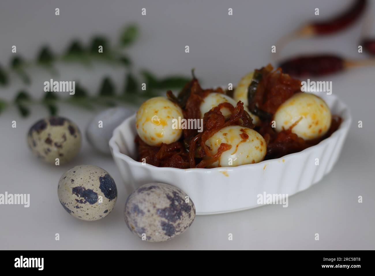 Quail egg roast cooked kerala style. It is made by mixing hardboiled ...