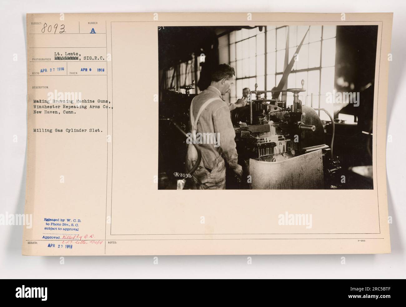 Soldier working on a Browning machine gun at the Winchester Repeating ...