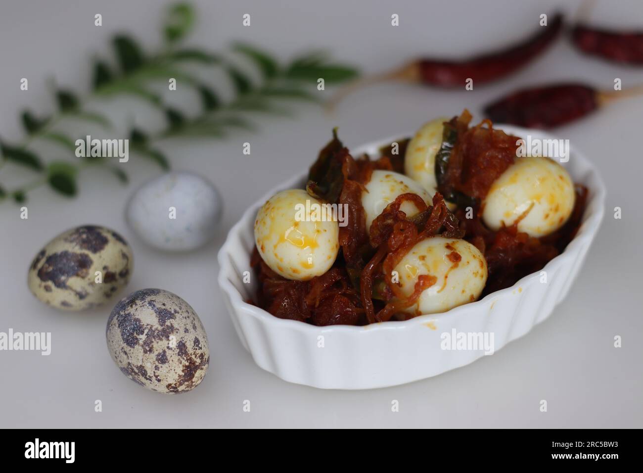 Quail egg roast cooked kerala style. It is made by mixing hardboiled ...