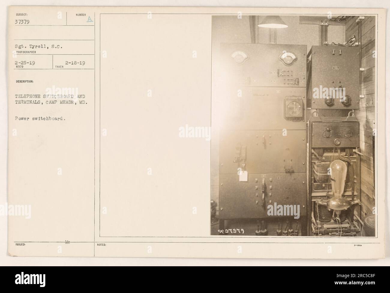 Sgt. Tyrell operating a telephone switchboard and terminals at Camp ...