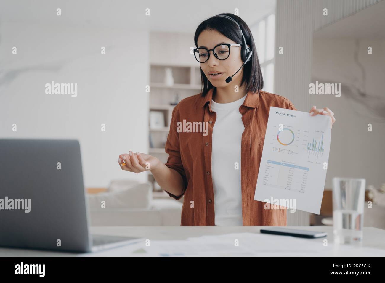 Business coach conducts online lesson, shows infographic on laptop ...