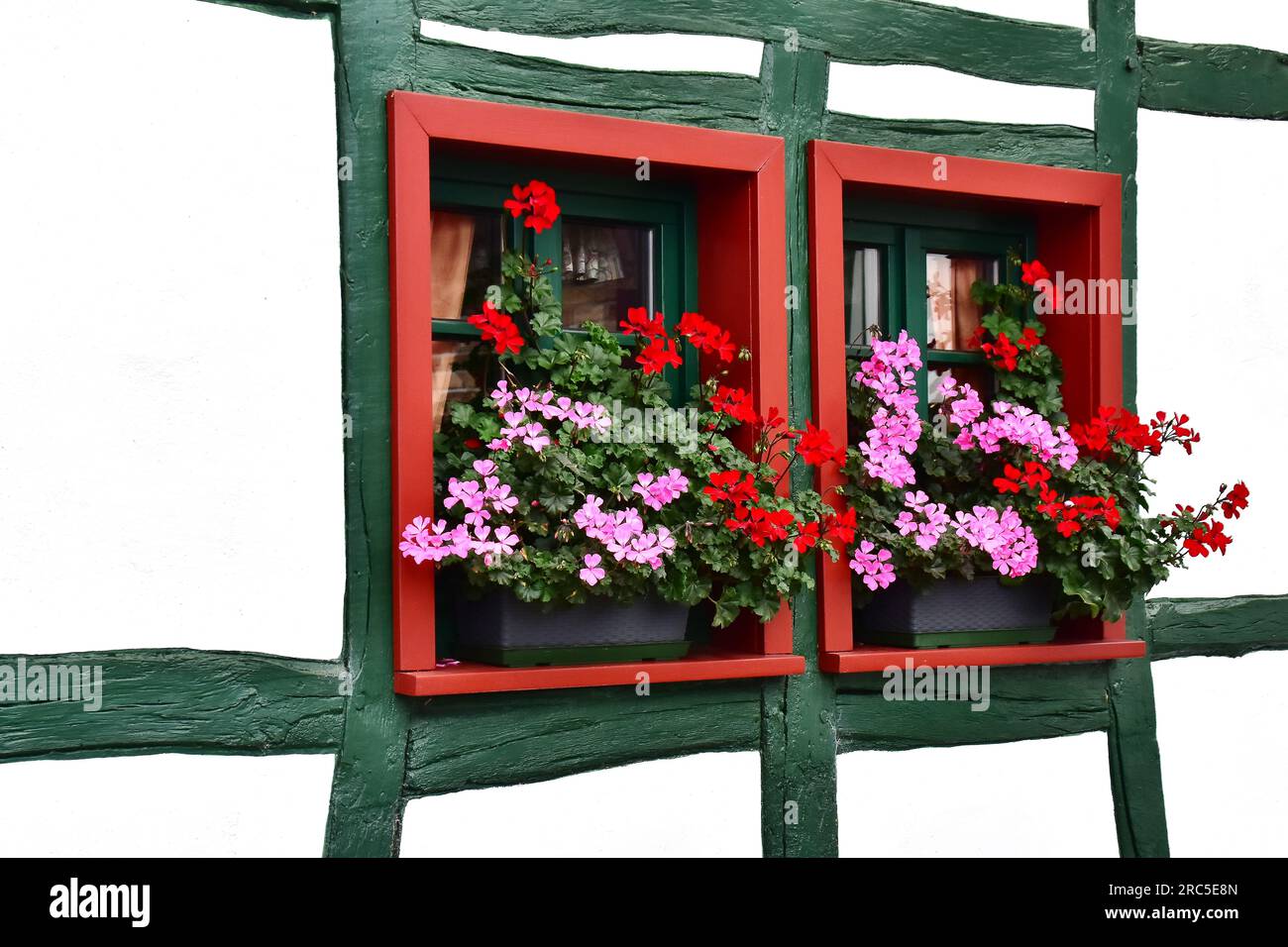 A beautiful window of a half-timbered house with flowers Stock Photo ...