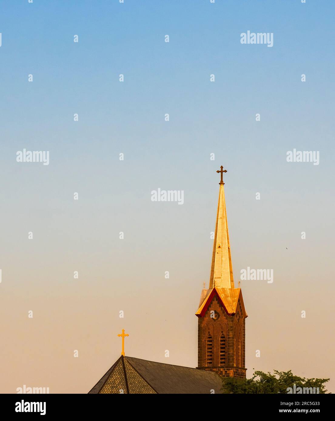 Tall church steeple with cross on top Stock Photo - Alamy