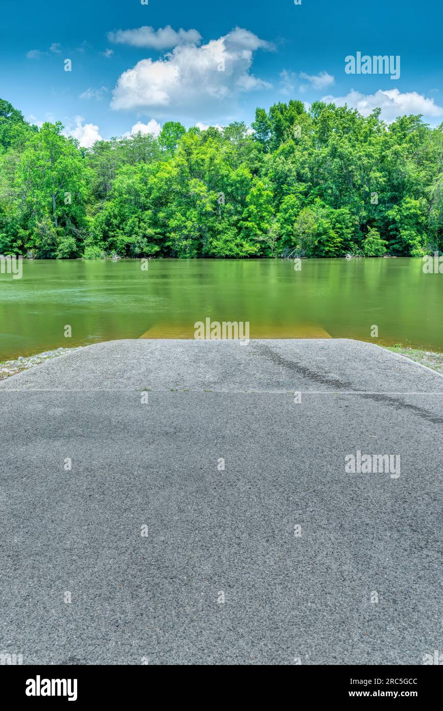 Vertical shot of a boat ramp on the Tennessee River with copy space ...