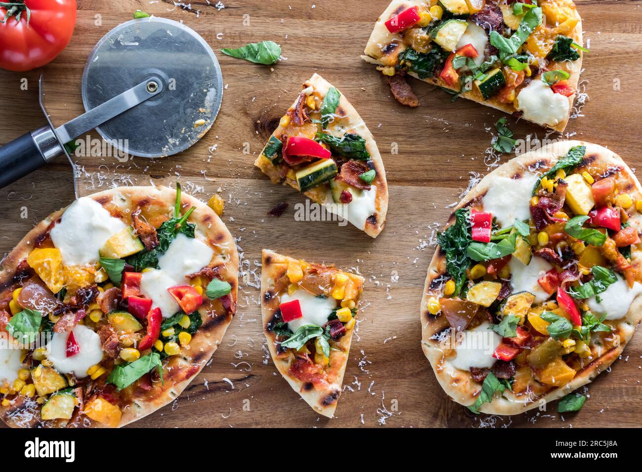 Homemade summer garden pizzas on grilled naan bread Stock Photo - Alamy