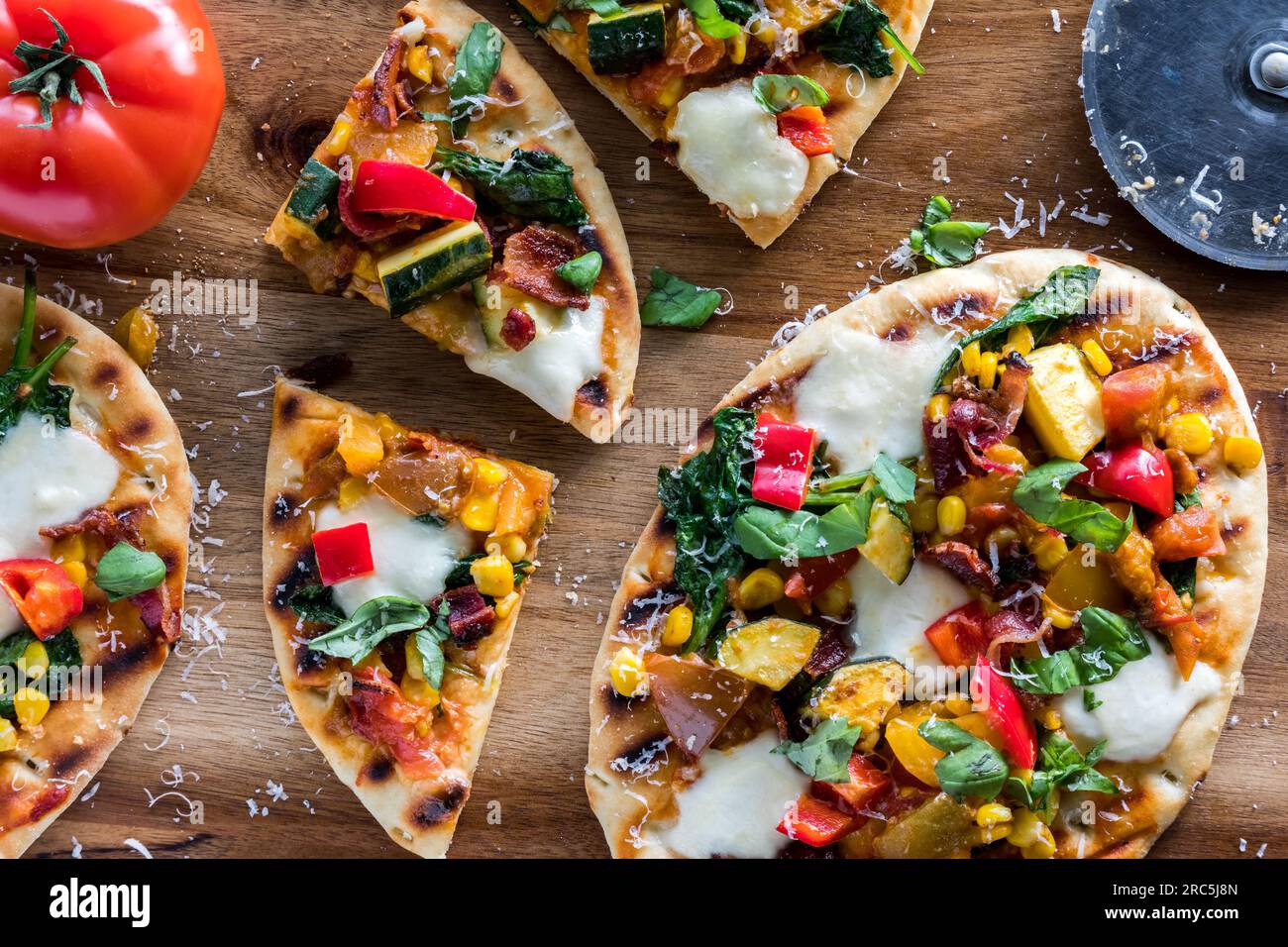 Homemade summer garden pizzas on naan bread, ready for eating Stock ...