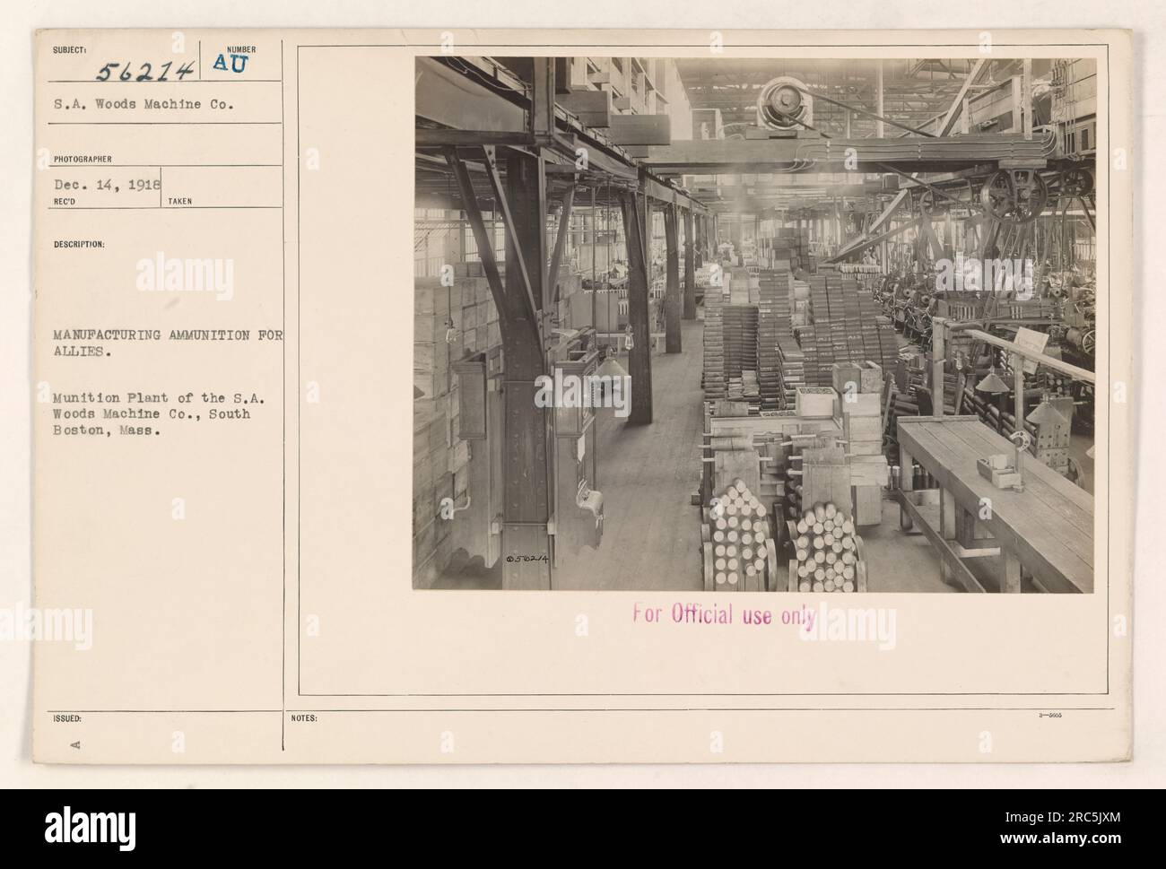 Workers operate heavy machinery at the munition plant of the S.A. Woods ...