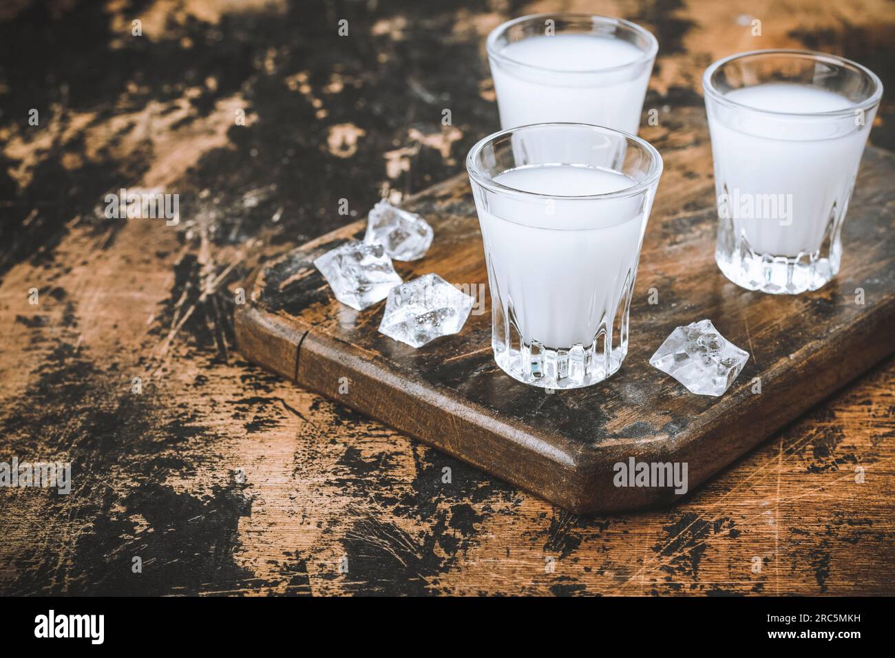 Traditional greek vodka ouzo and marinated olives on rustic wooden ...