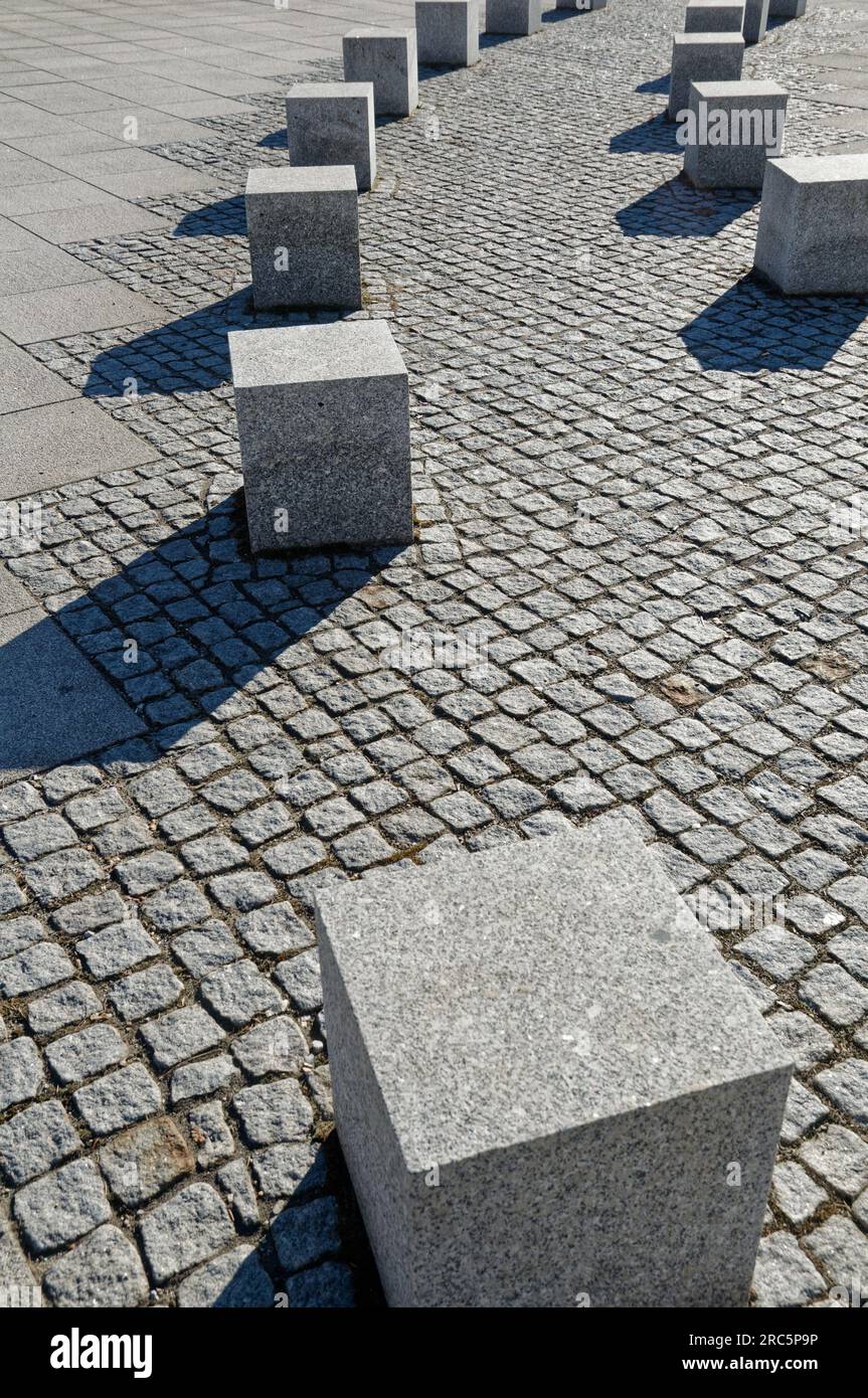 A geometric pattern of grey concrete blocks arranged in a circular ...