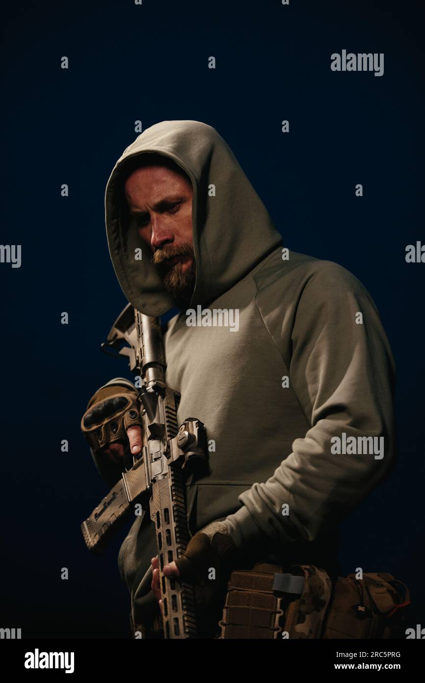 Armed Ukrainian soldier holding his rifle in a dark background Stock ...
