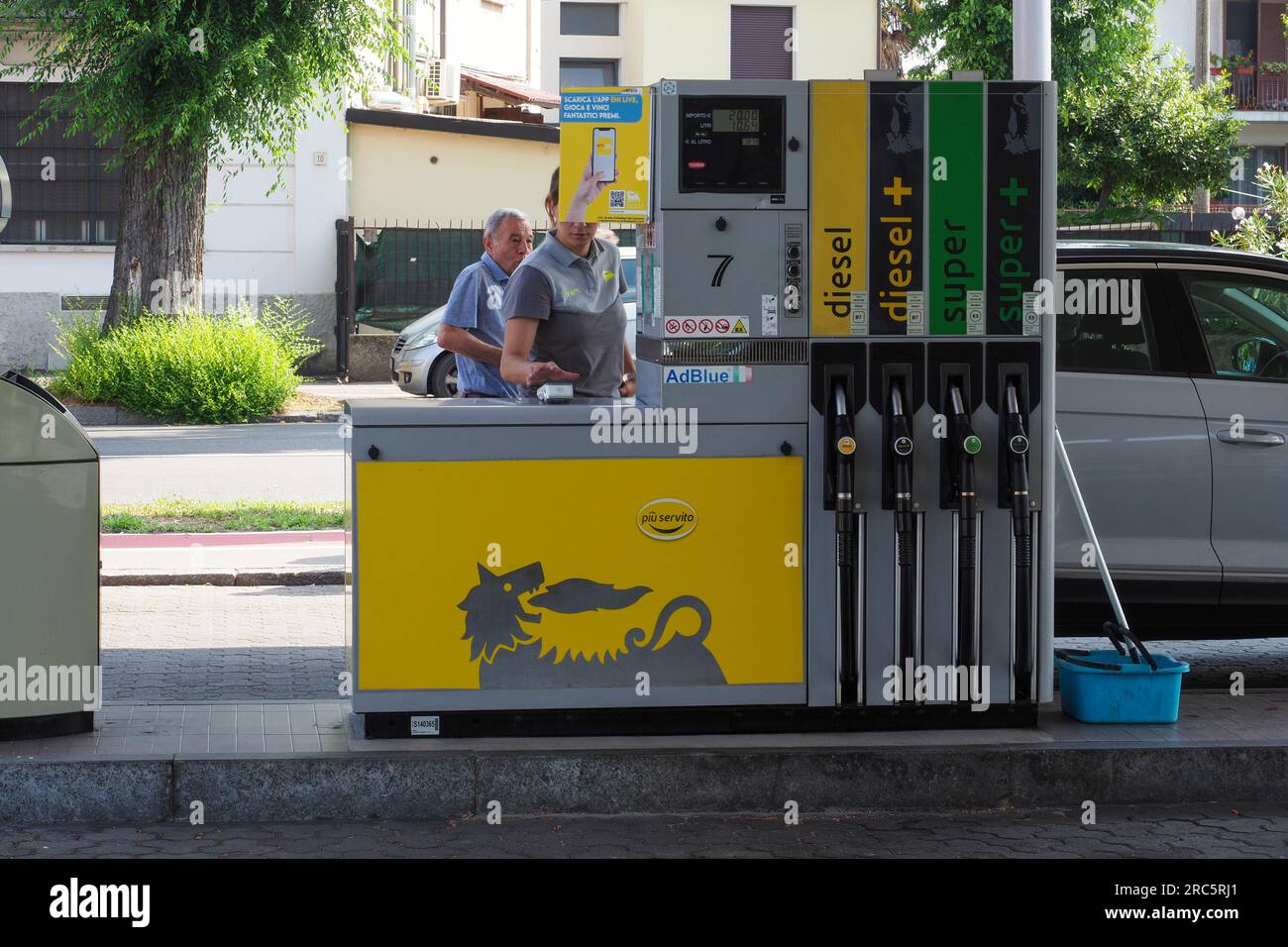 Cremona, Italy - July 3 2023 gas station attendant woman taking payments with credit card from ...