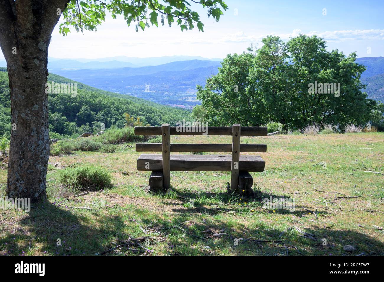 Wooden bench in the middle of nature with views of the mountains in the ...