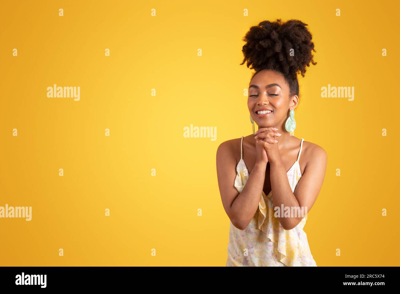Happy millennial african american woman in dress making pray gesture ...