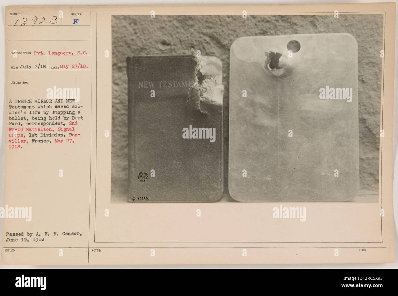 Soldier, Bert Ford, holds a trench mirror and a New Testament that ...