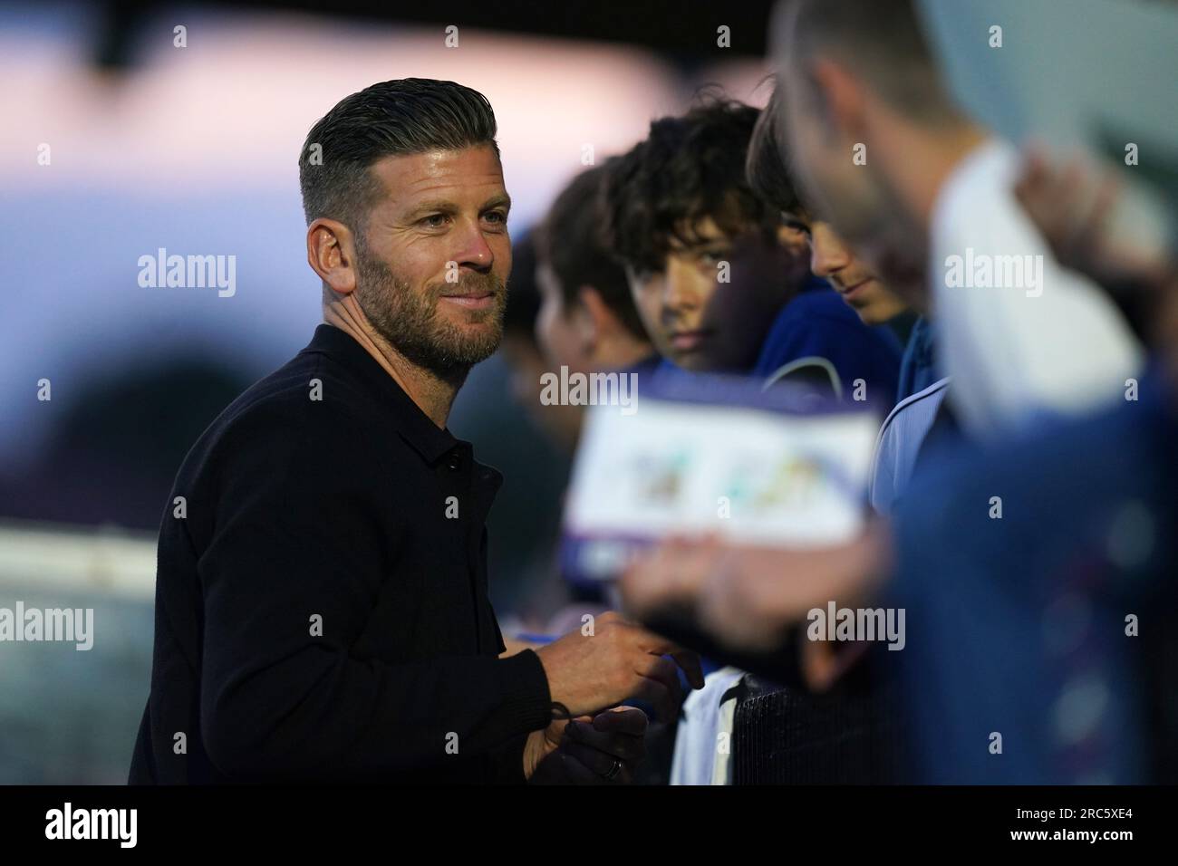 Boreham Wood manager Luke Garrard signs autographs after a friendly ...