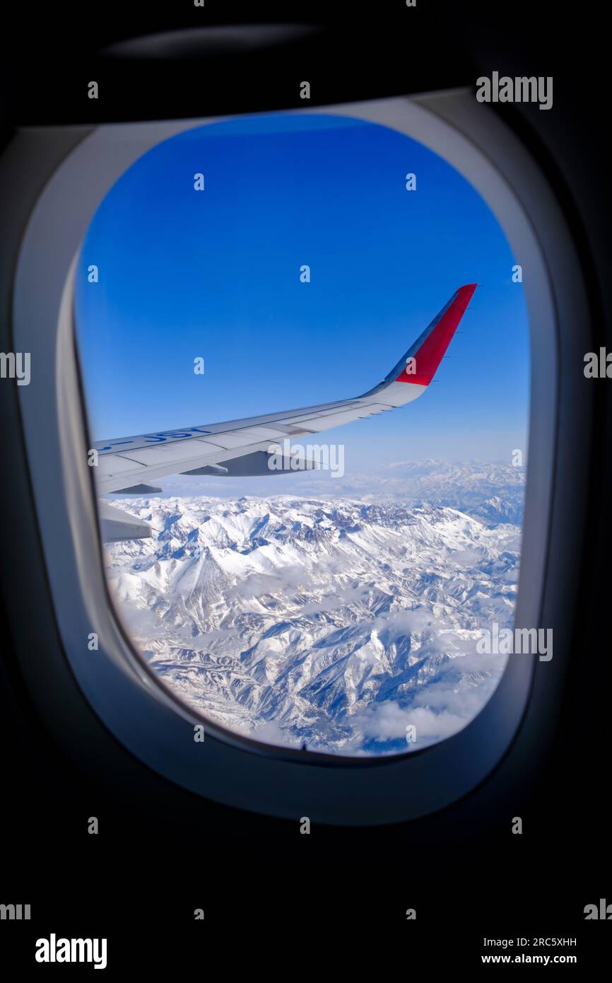 Classic image through aircraft window onto wing. Flight view over ...