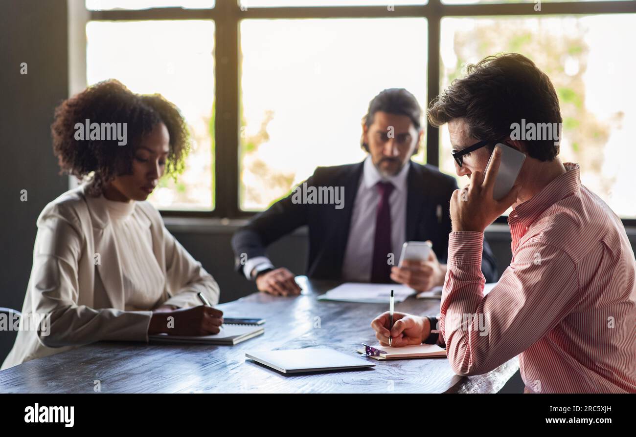 Concentrated multicultural colleagues gathering in boardroom ...