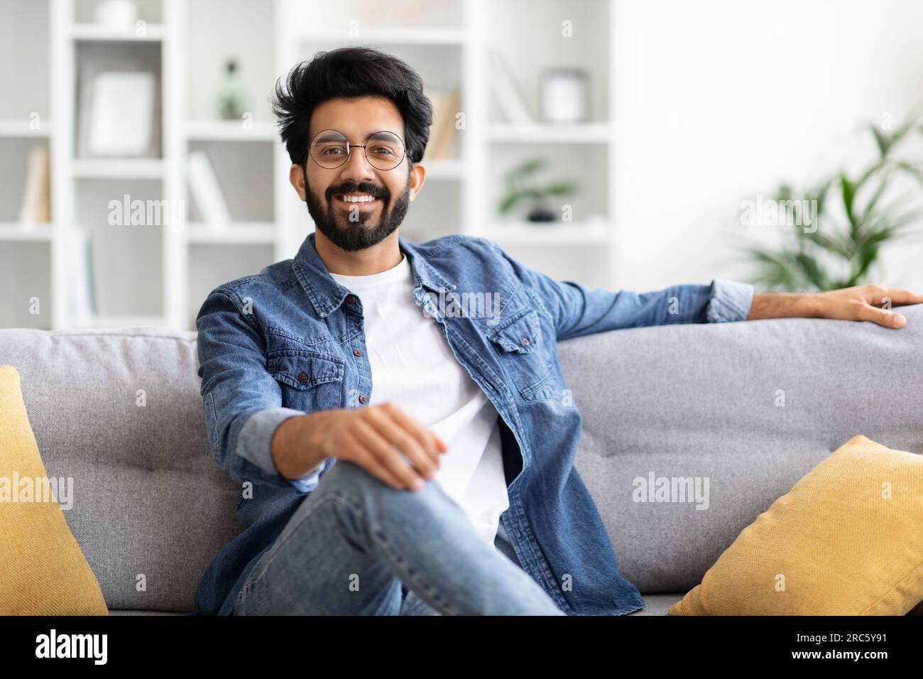 Portrait Of Handsome Young Indian Guy Posing On Couch In Home Interior ...