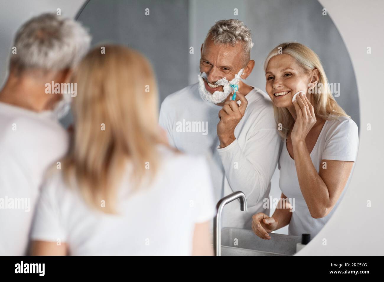 Morning Routine. Happy Mature Couple Getting Ready Together Near Mirror ...