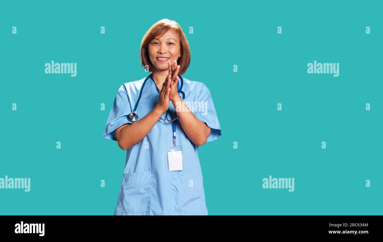 Approving smiling nurse happily clapping hands, satisfied with ...