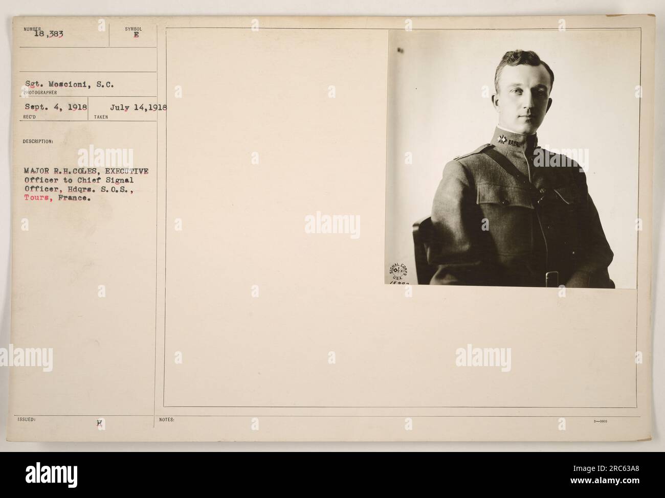 American soldier writing in notebook, surrounded by military maps ...