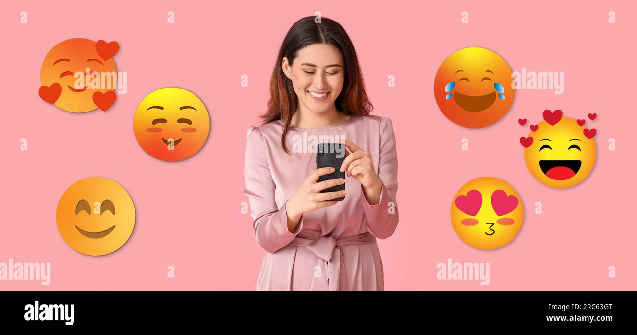 Happy Asian woman with mobile phone and different smiling emoticons on ...