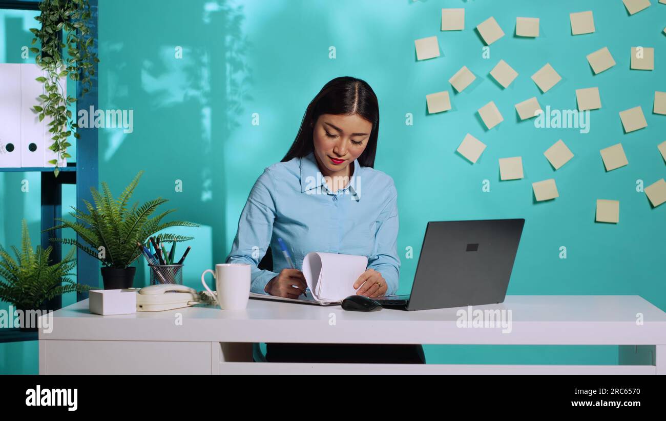 Office clerk cross checking paperwork hi-res stock photography and ...