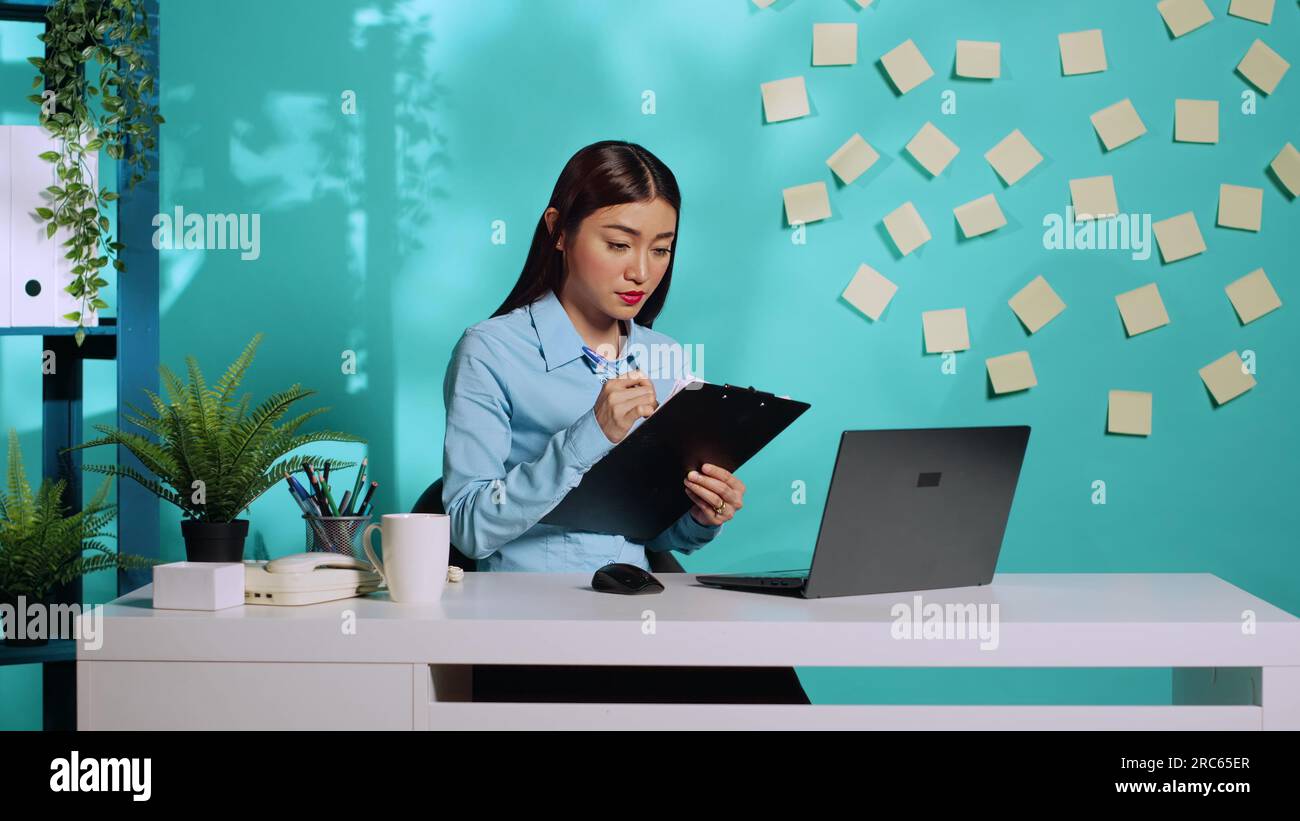 Office clerk cross checking paperwork hi-res stock photography and ...