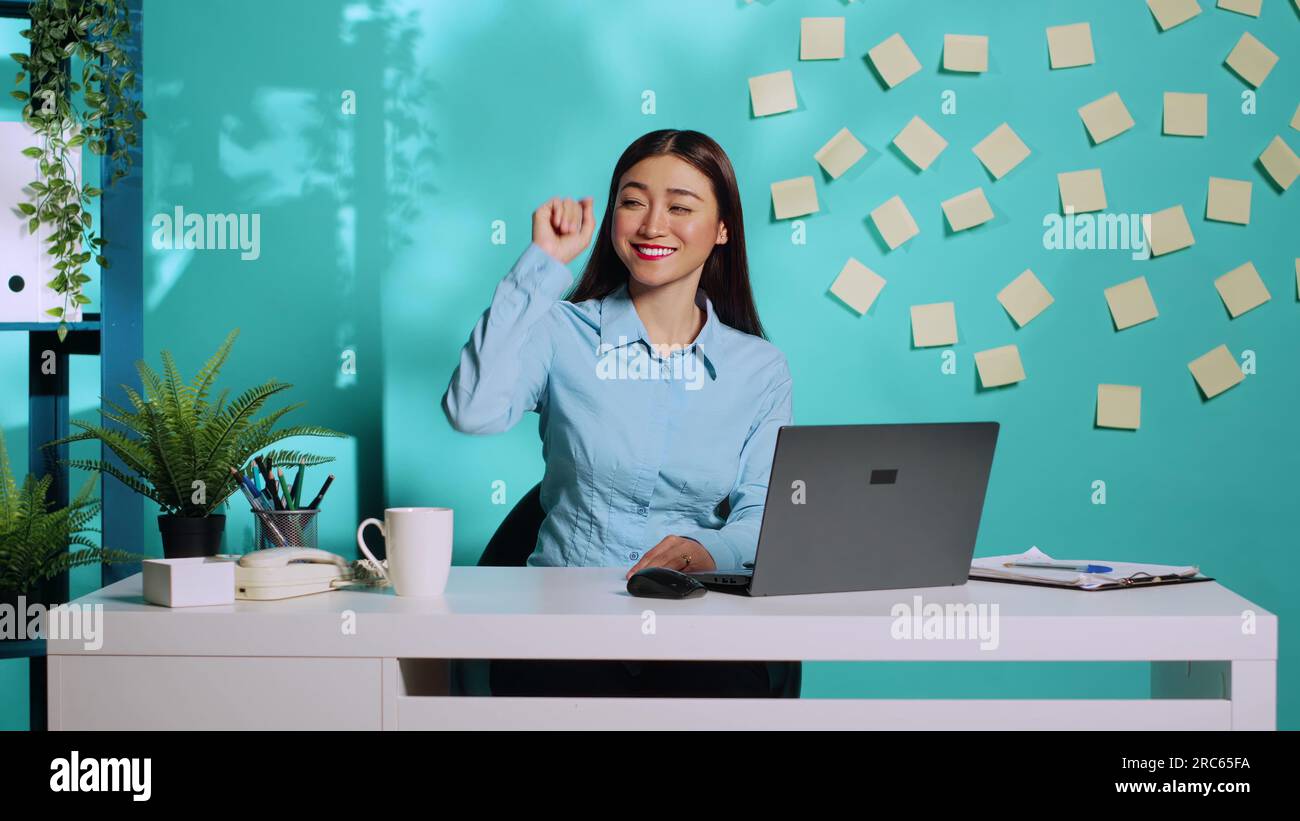 Cheerful chipper upbeat asian woman pointing upward, leftward and ...